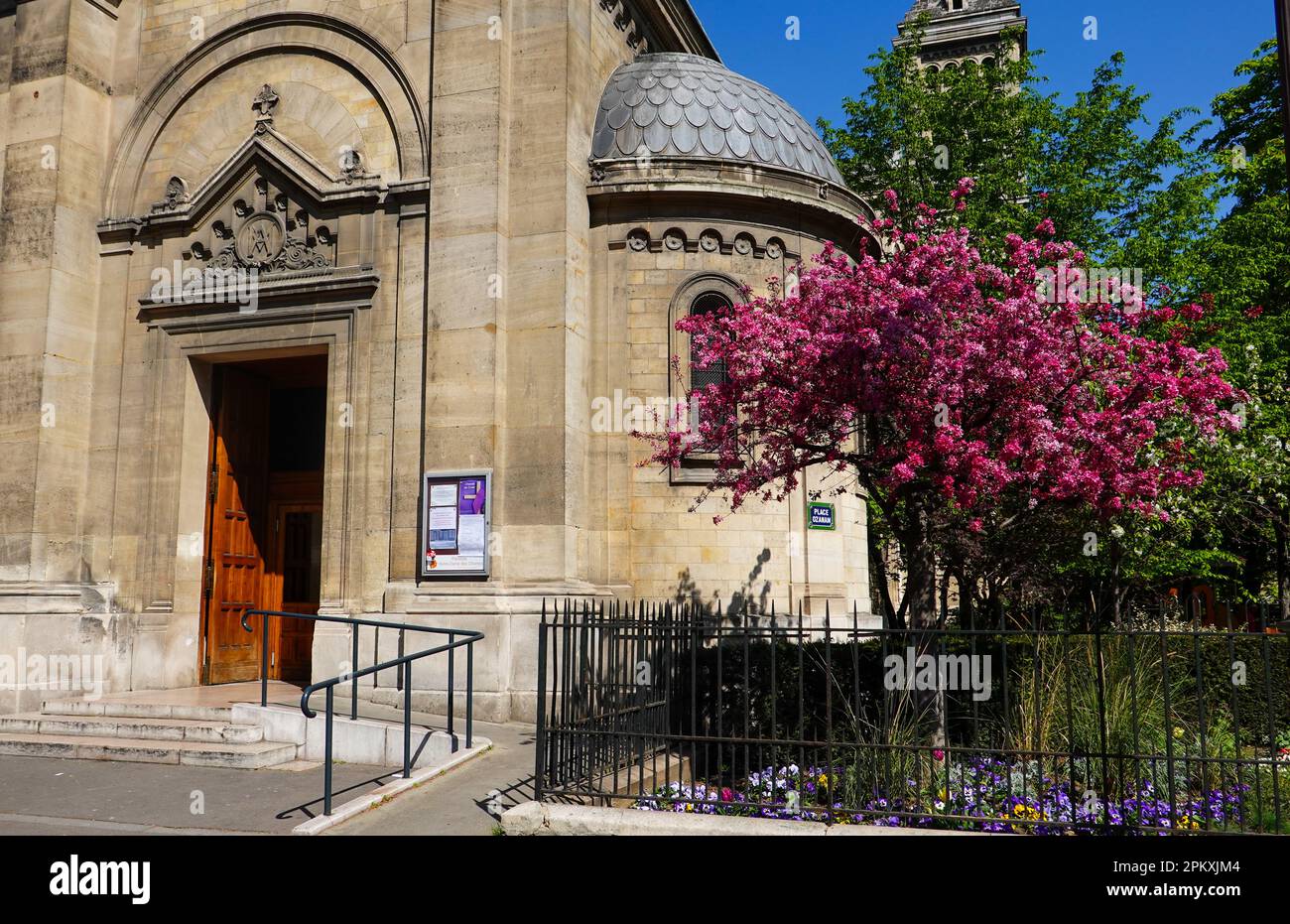 L'église Notre Dame des Champs and brilliant purple spring blossoms in ...