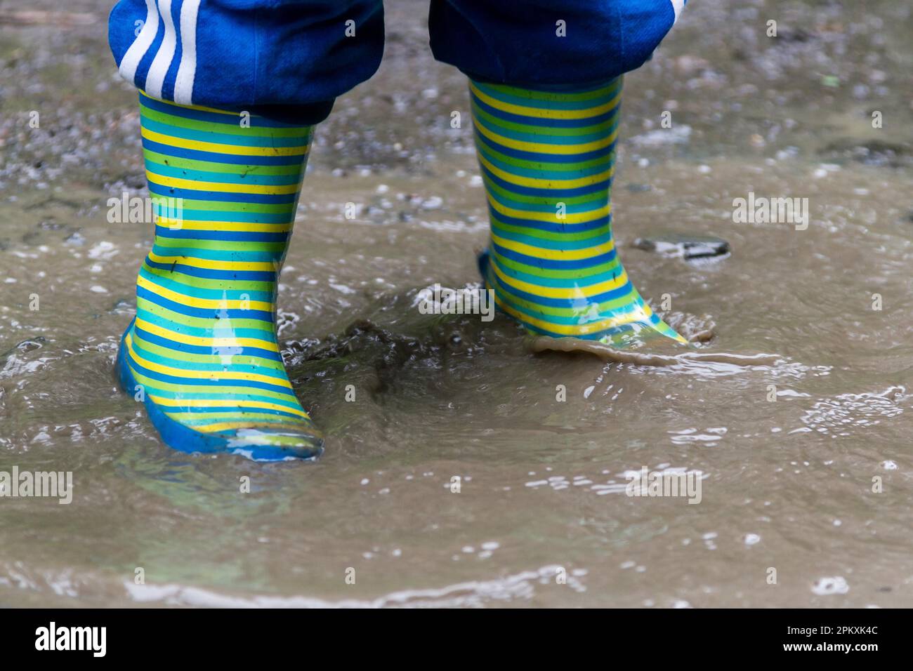 Child playing in the puddle Stock Photo - Alamy