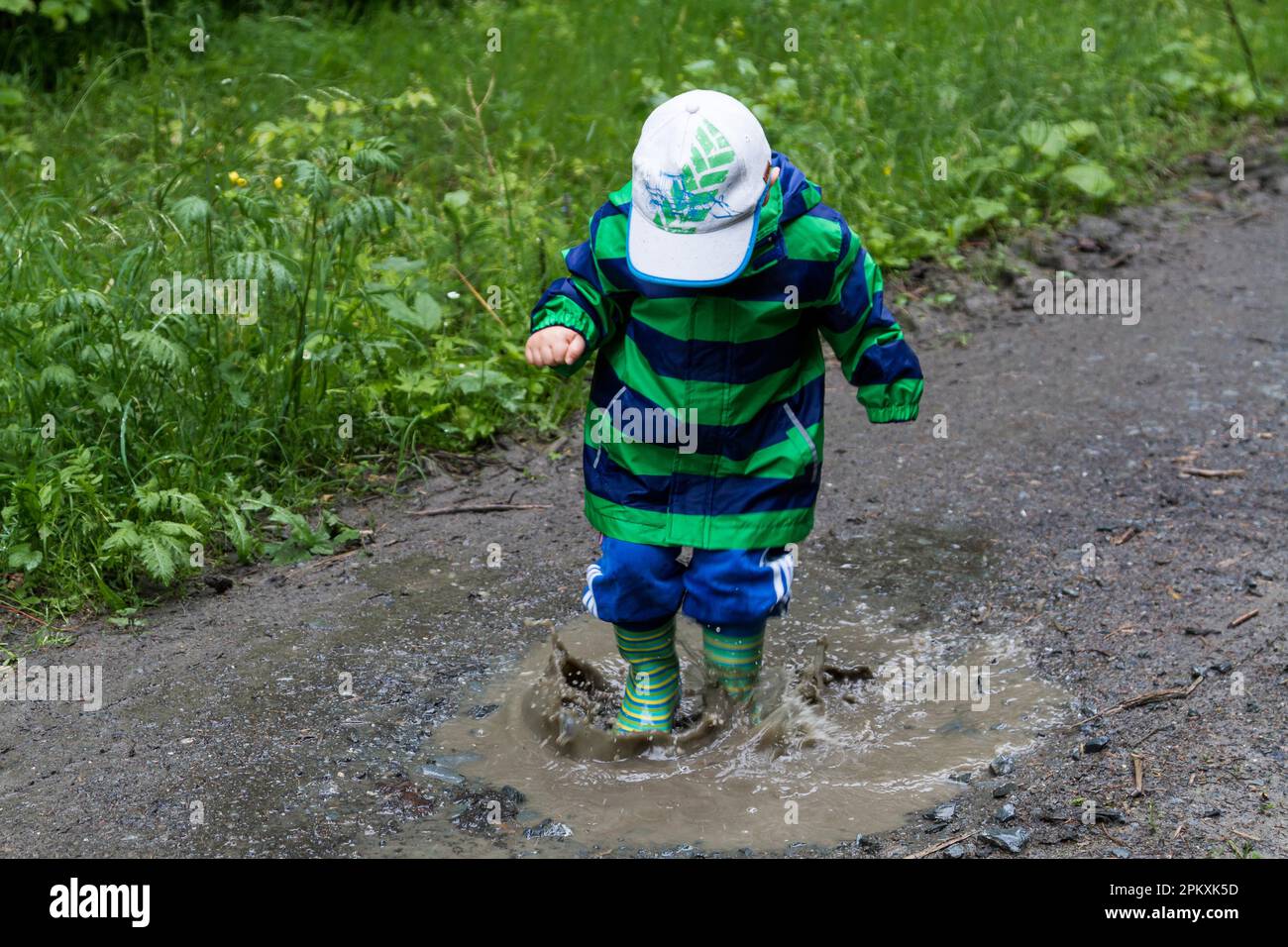Child playing in the puddle Stock Photo - Alamy