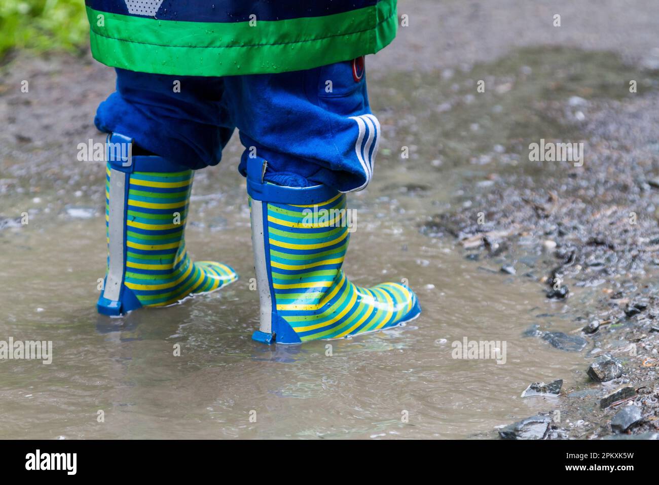 Child playing in the puddle Stock Photo - Alamy
