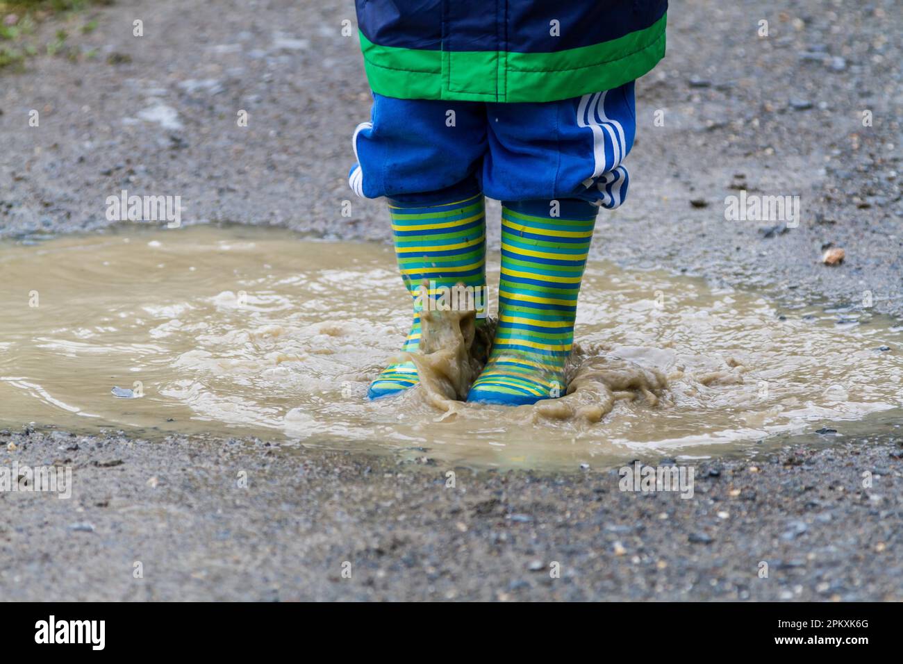 Child playing in the puddle Stock Photo - Alamy