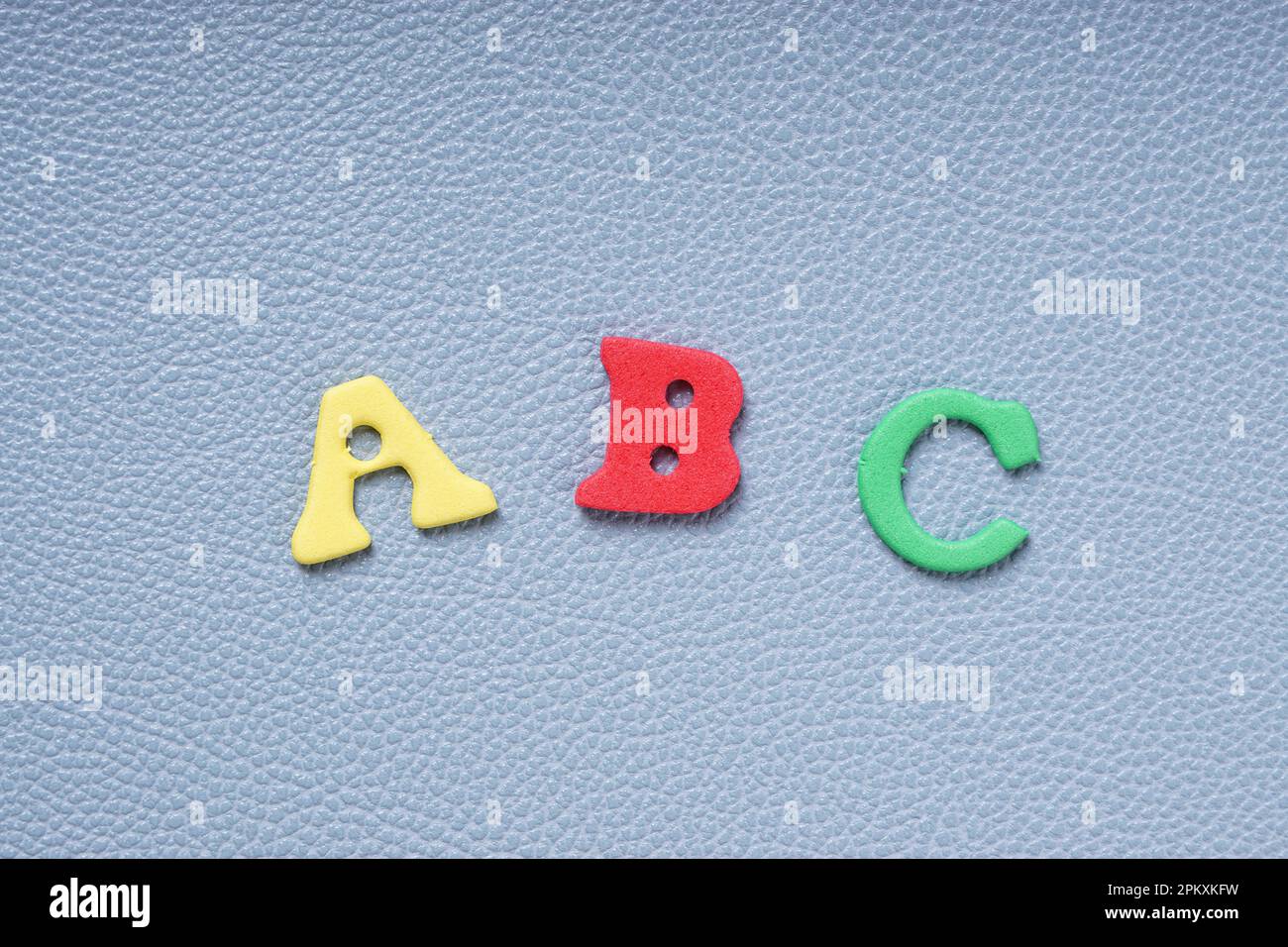 ABC in colorful foam rubber letters on blue background Stock Photo - Alamy
