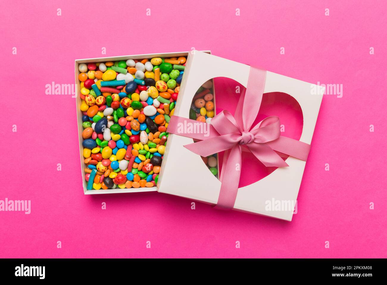Box with sweet chocolate candies on color background, Various candy ...