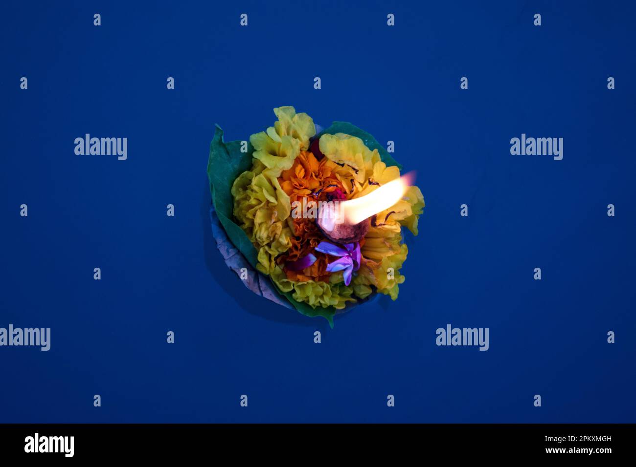 Flower and diya floating in ganga Stock Photo - Alamy