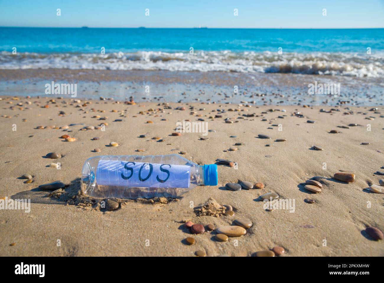 Sea plastic contamination. SOS message in a plastic bottle on the sea ...