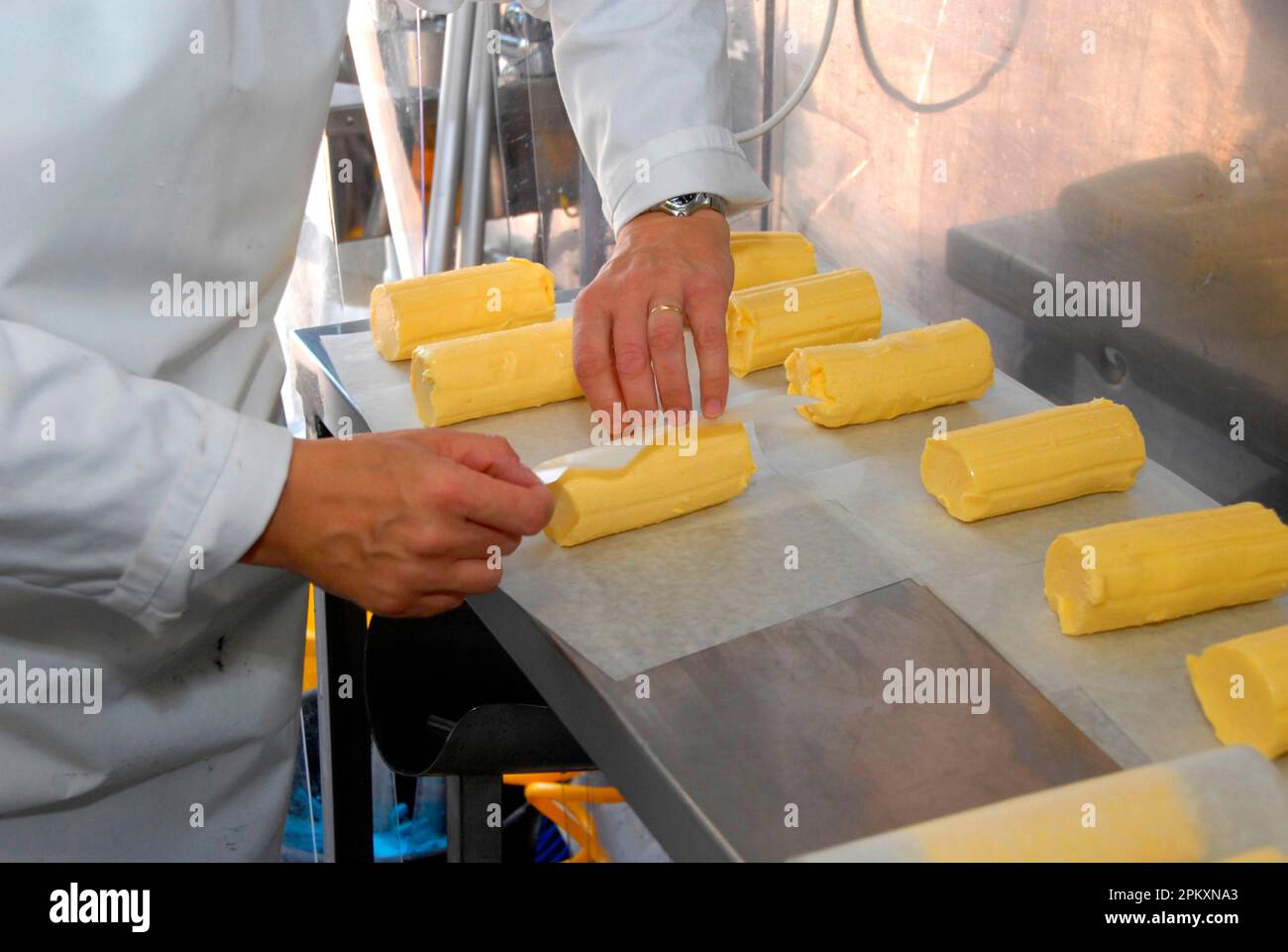 Worker wrapping organic butter made from unpasteurised milk, at an ...