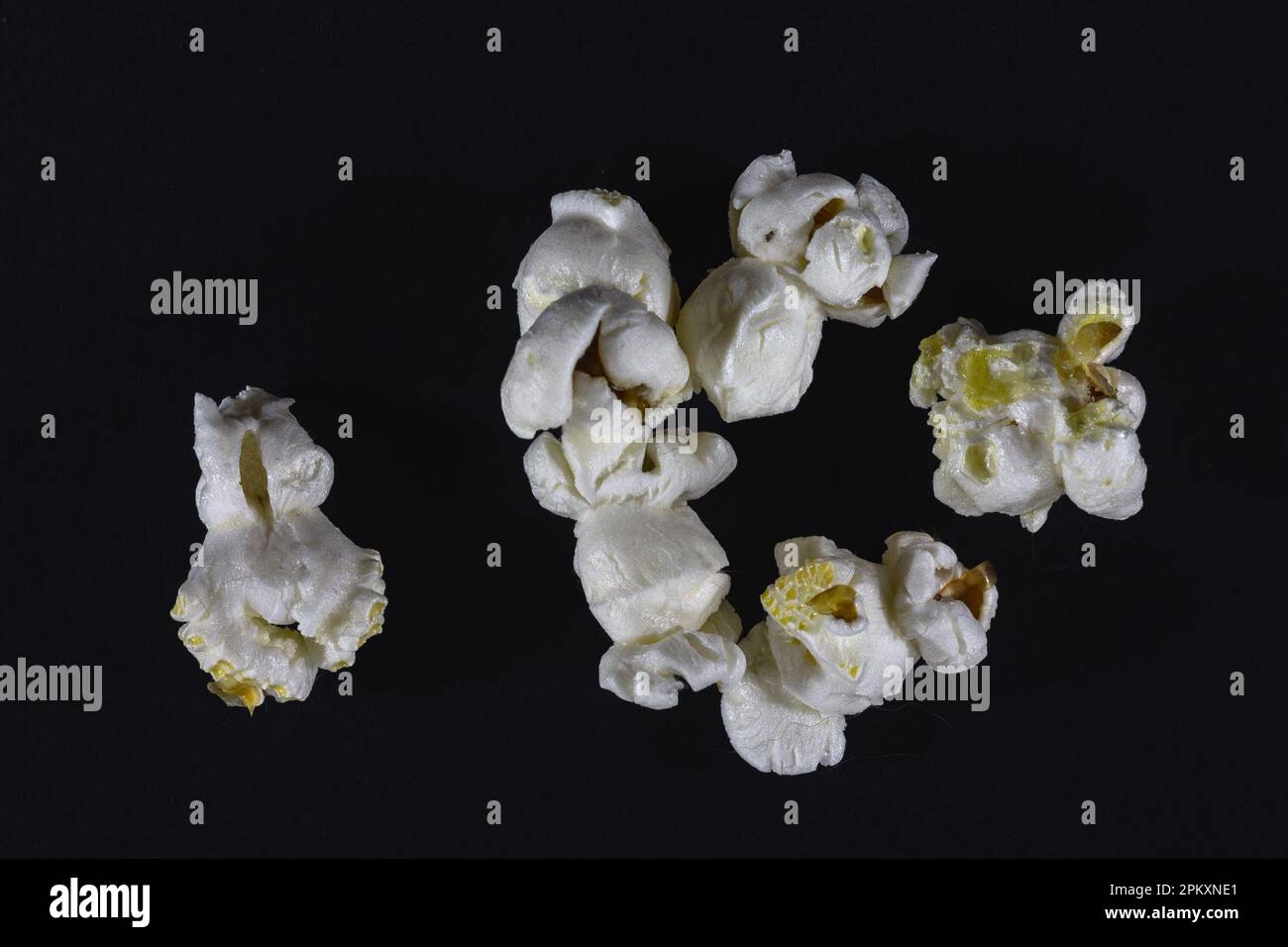 Picture of isolated white popcorn on black background. Popcorn is a ...