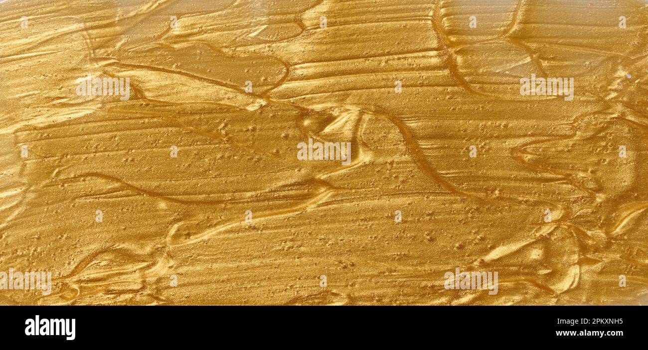 Sample of golden glitter gel with small particles, texture of ...