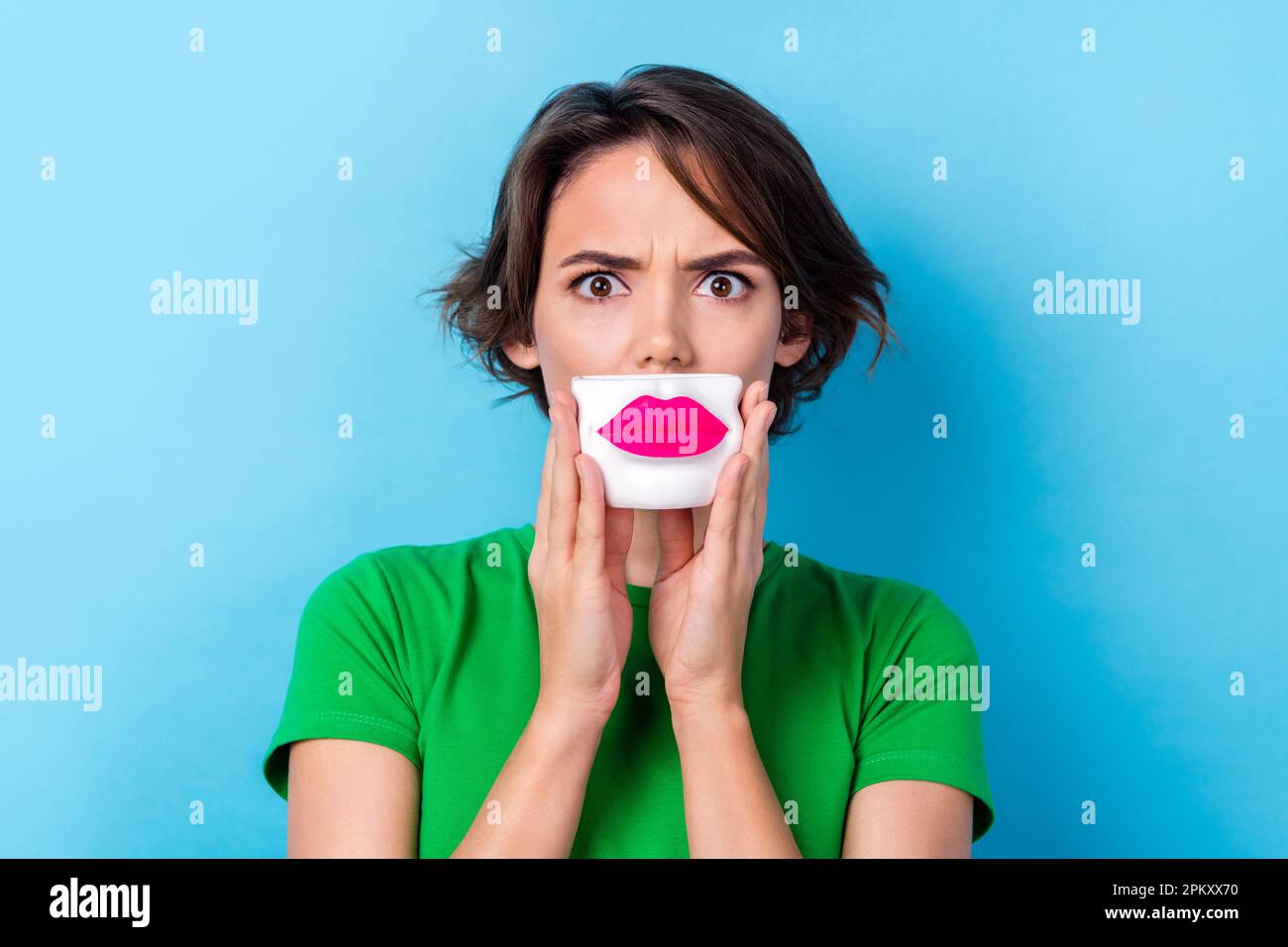 Portrait of young excited shocked woman hold plastic lips pomade ...