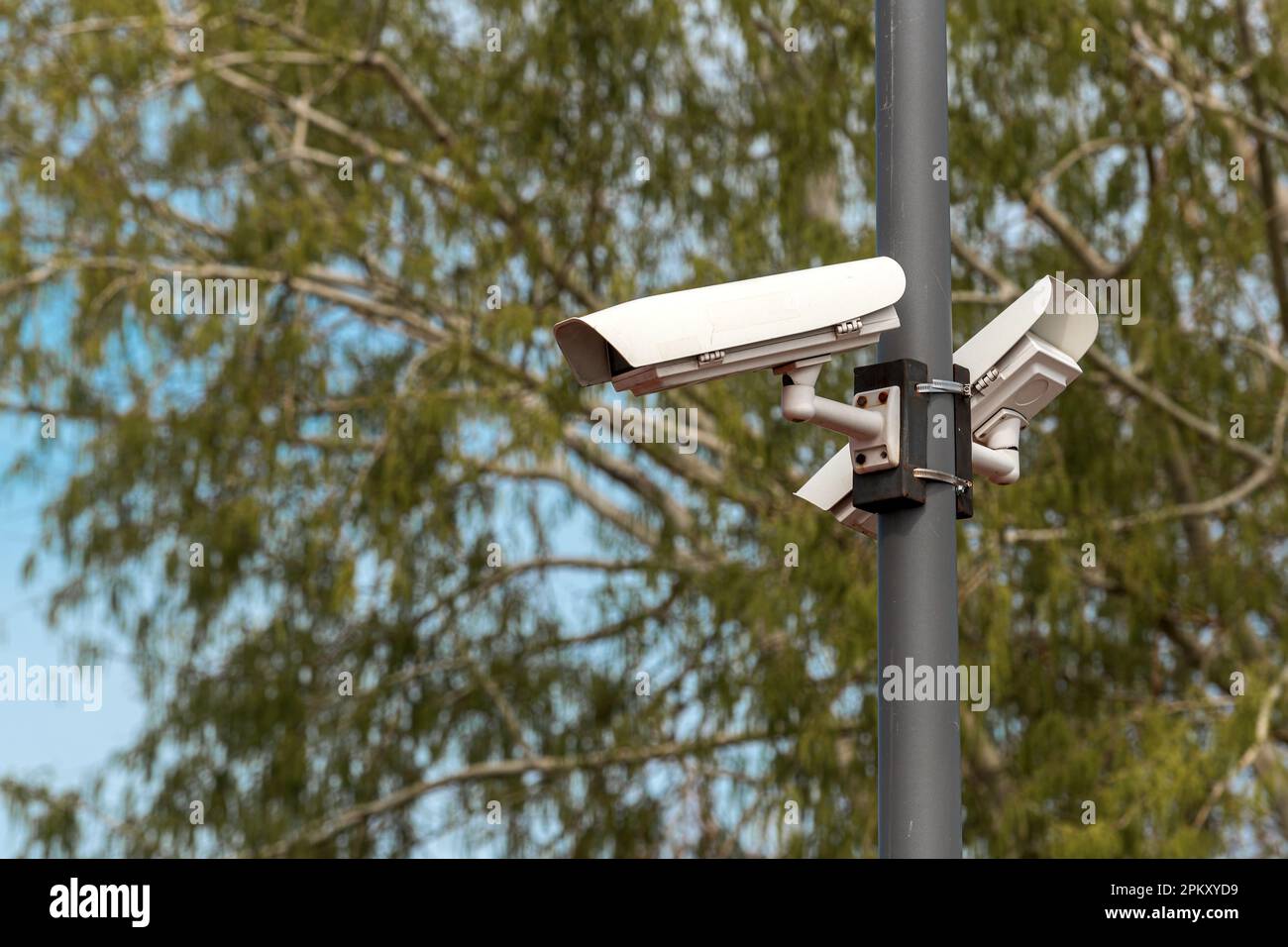 Security cameras mounted on post in public park, selective focus Stock ...
