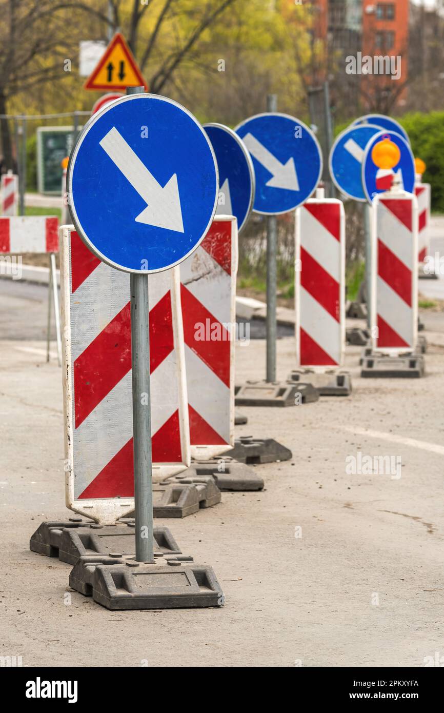 Mandatory keep right obstacle detour road sign and safety barrier ...