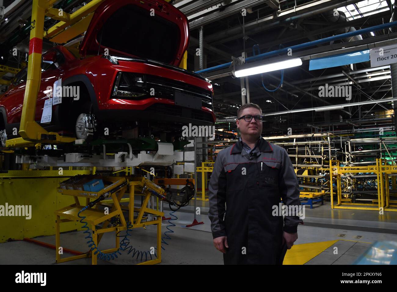 Moscow. A worker assembling a car on the production line of the Moscow ...