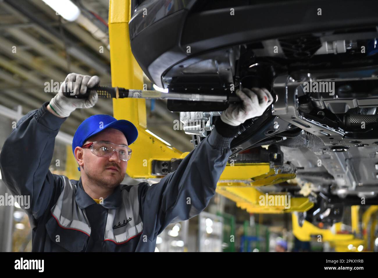 Moscow. A worker assembling a car on the production line of the Moscow ...