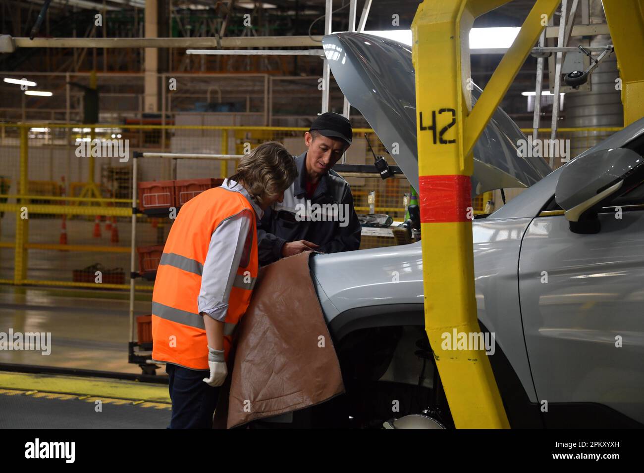 Moscow. Workers assembling a car on the production line of the Moscow ...