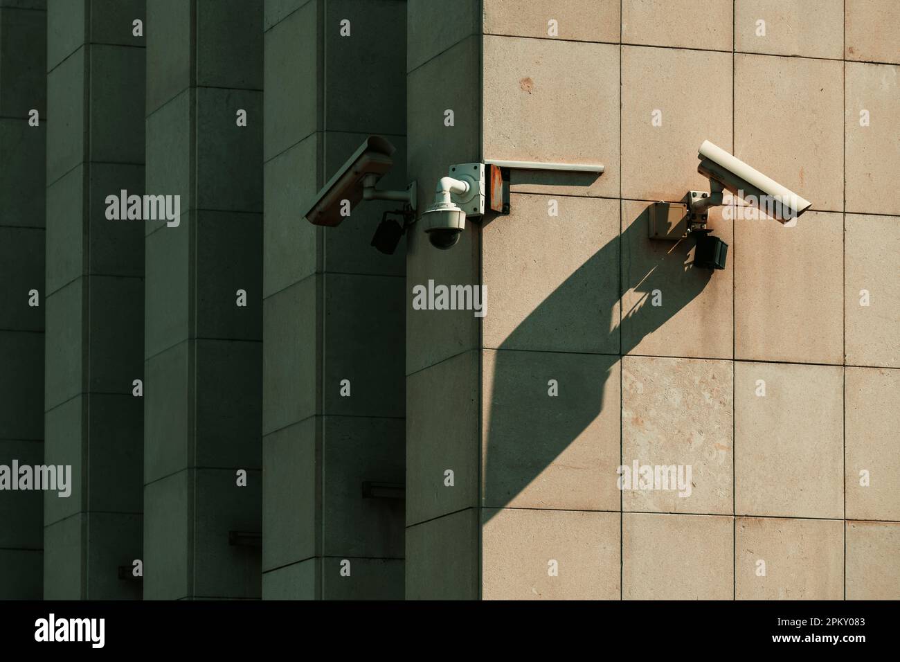 Old worn surveillance security cameras mounted on building wall ...