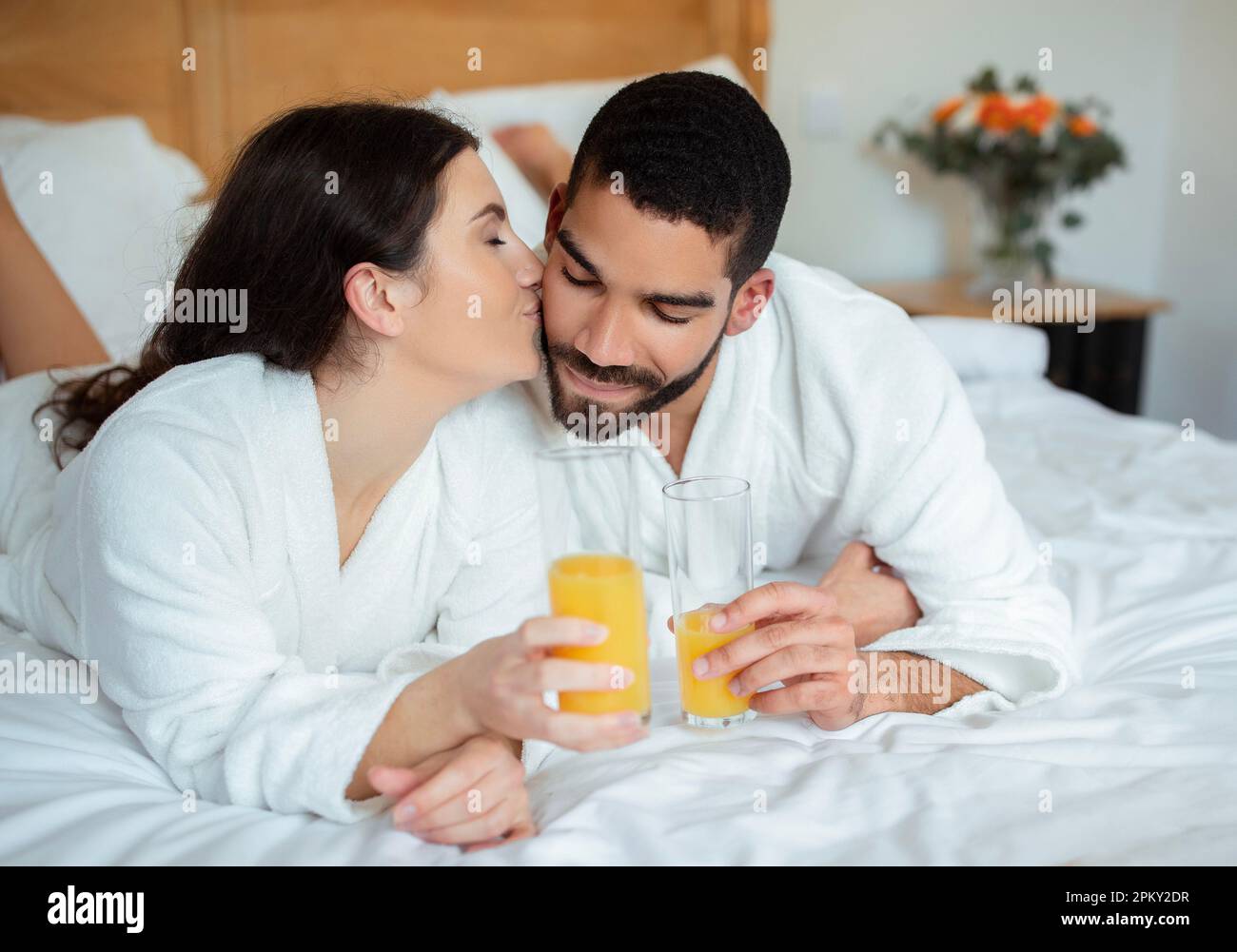 Wife Kissing Husband's Cheek Drinking Juice Relaxing In Hotel Room ...