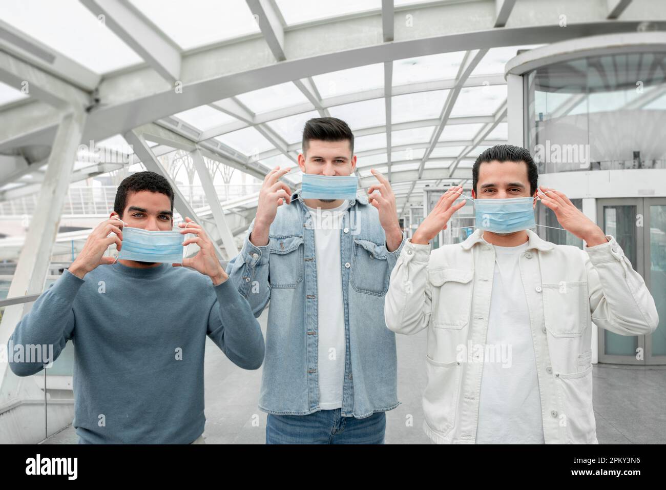 Three Males Showing How To Wear Face Masks In Airport Stock Photo - Alamy