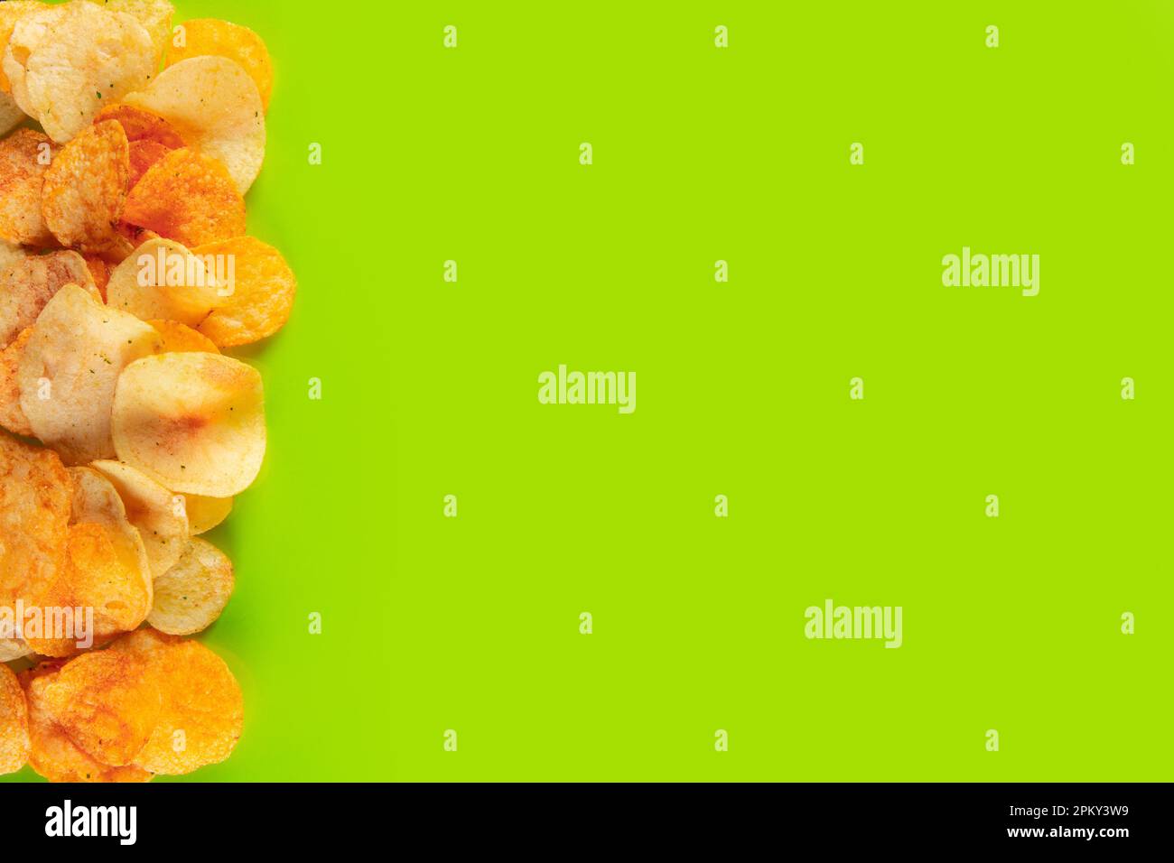 Border of potato chips isolated on vibrant light green background ...