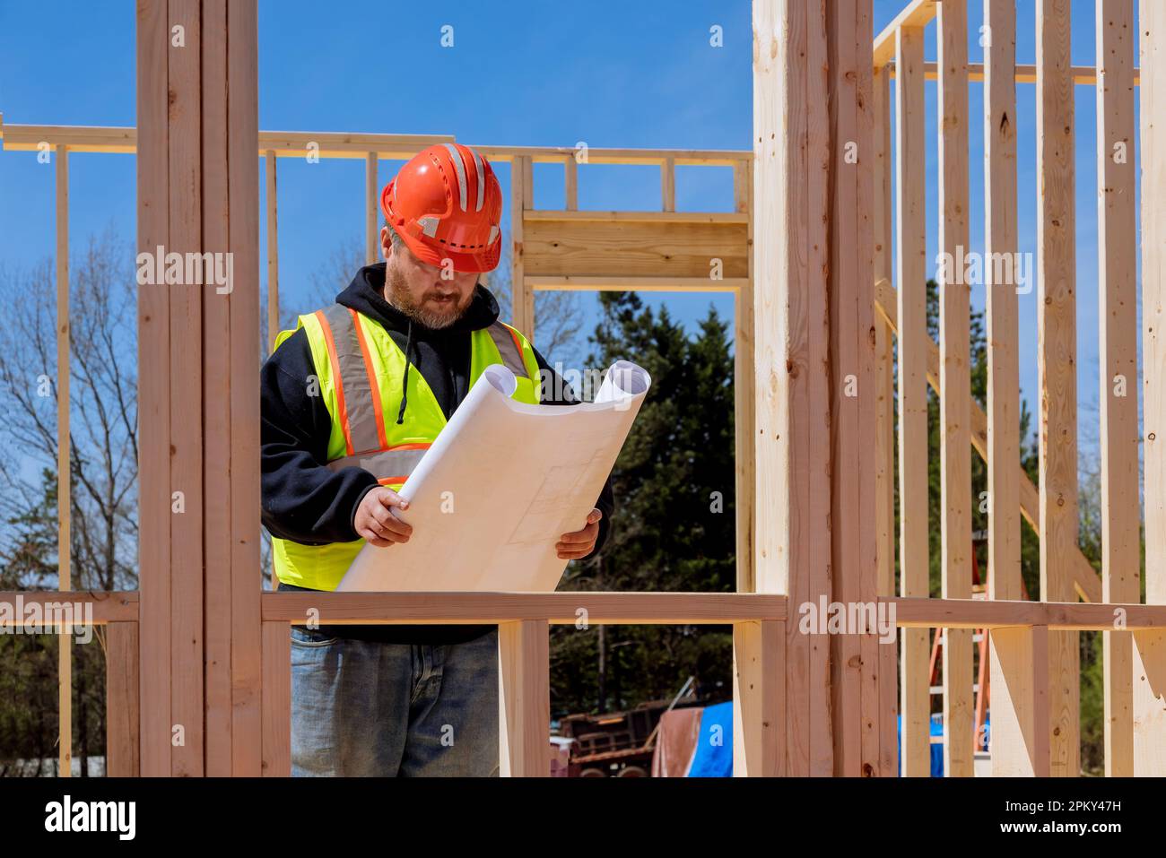 On construction site an inspector checks construction of home based on ...