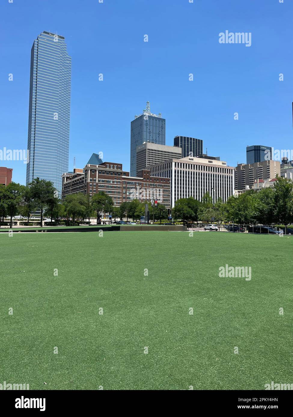 A rural landscape featuring a lush, grassy field dotted with trees and ...