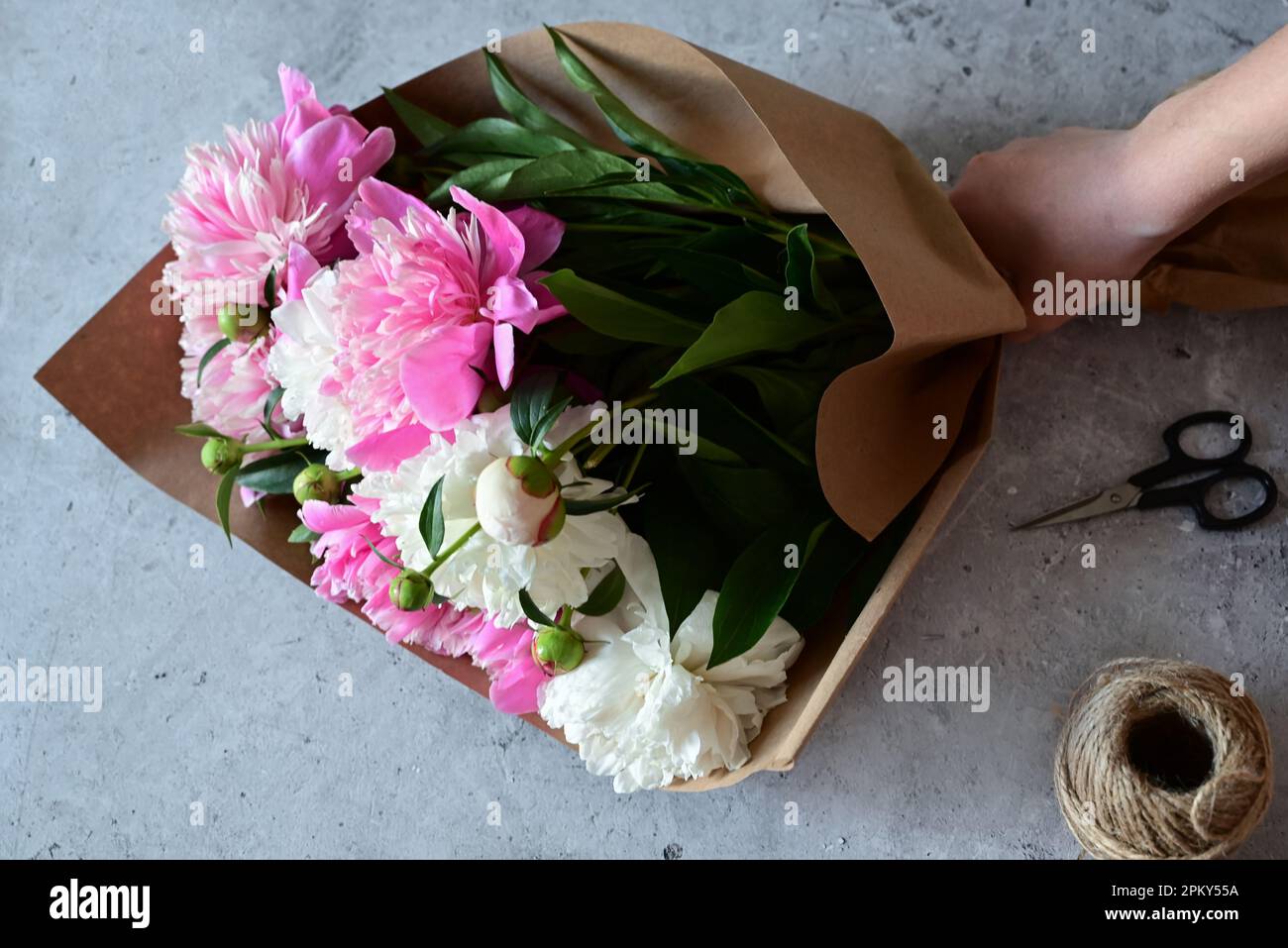 Florist makes a bouquet.a woman makes a bouquet of peonies, a bouquet ...