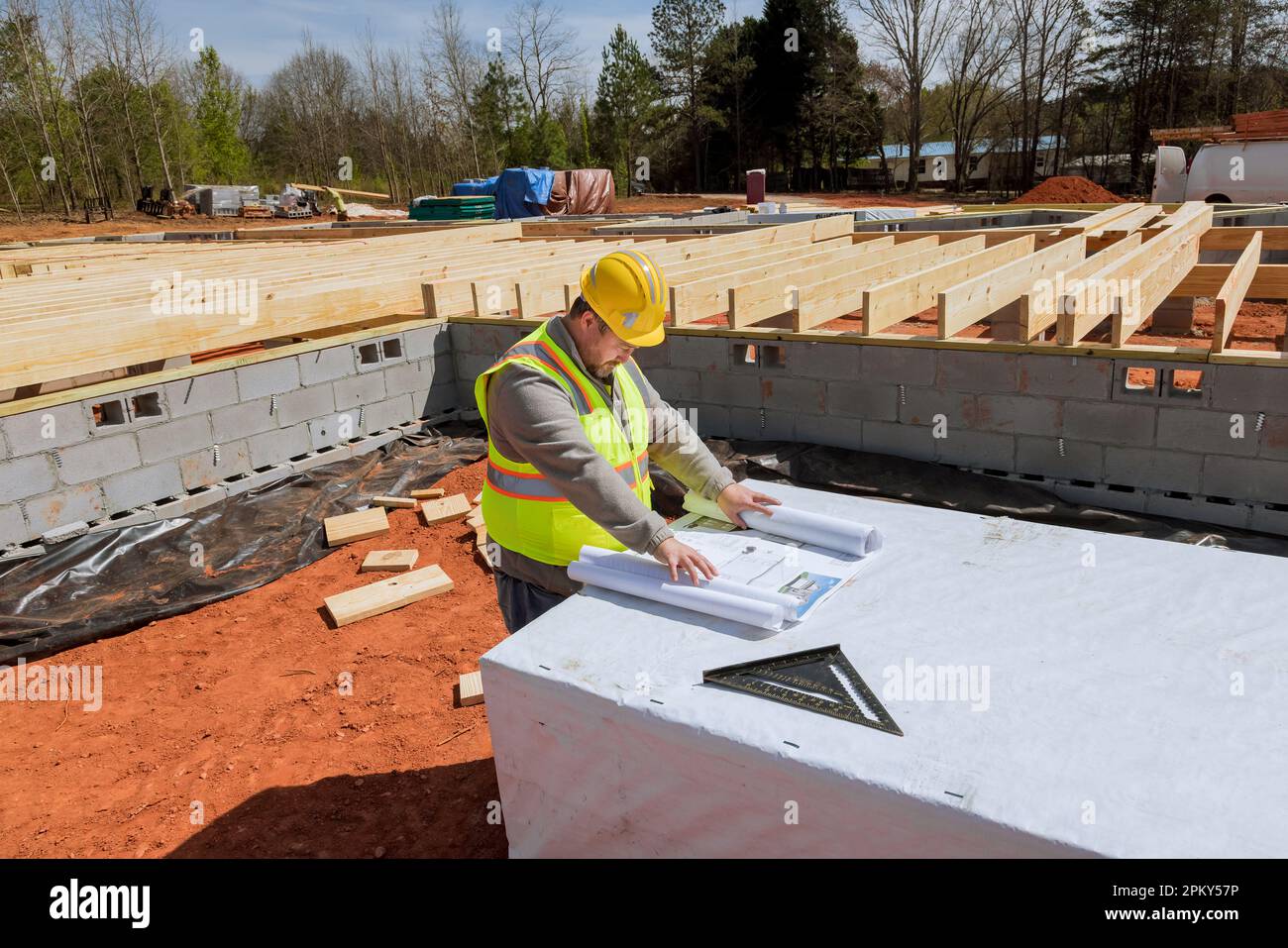 Construction supervisor in hard hat safety vest inspecting house ...