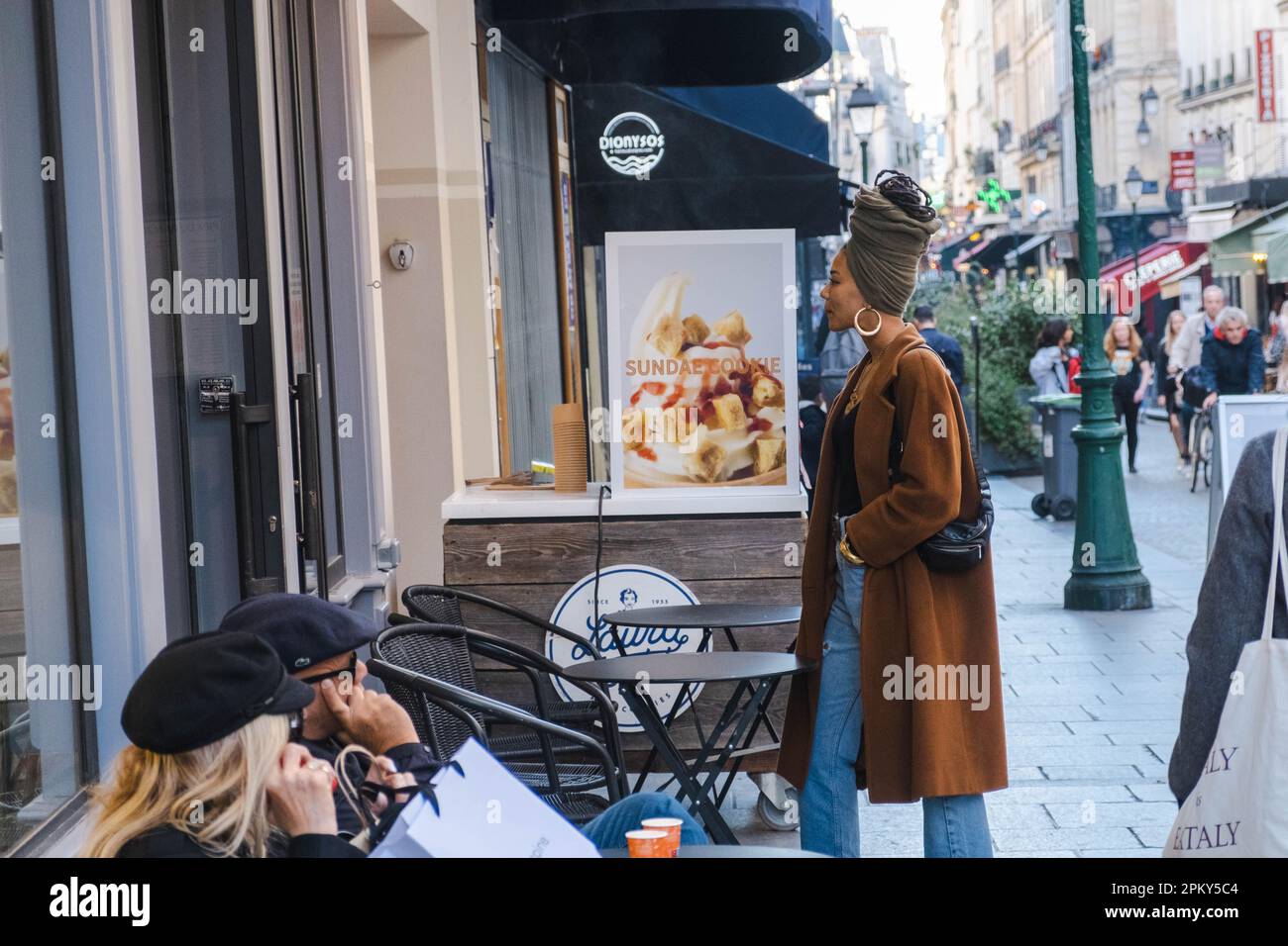 Stylish Black Woman Admiring Shop Windows in Chic Brown Coat with ...