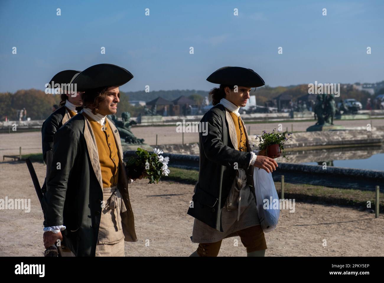 Victorian Era France: Male Servants in Elegant Attire Holding Flowers ...