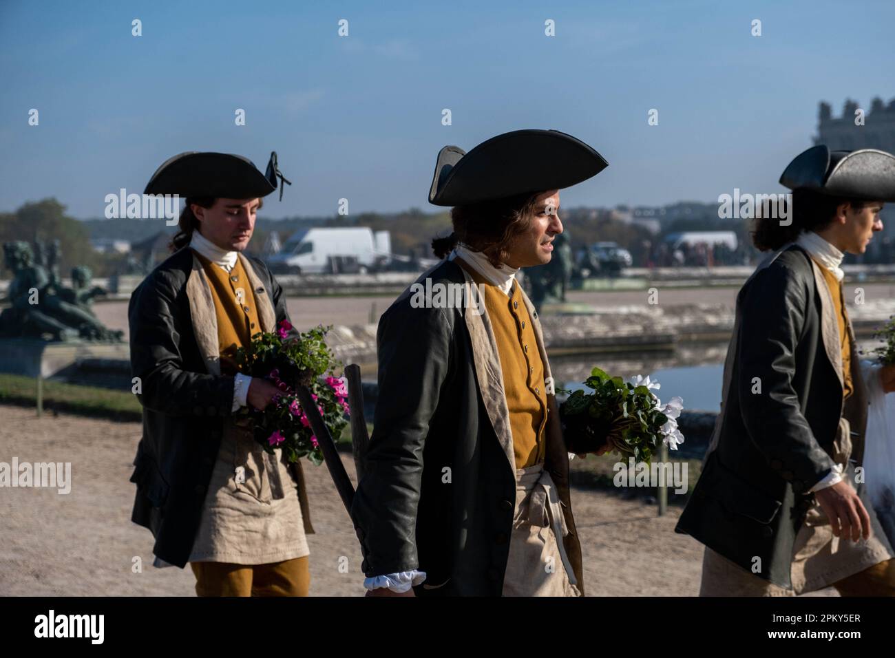 Victorian Era France: Male Servants in Elegant Attire Holding Flowers ...