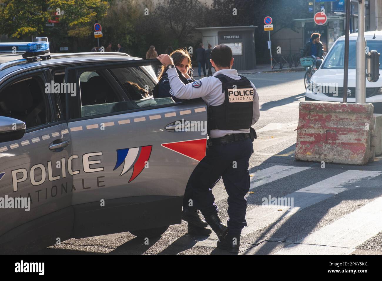 Male and Female Police Officers Engaged in Conversation Next to Police ...