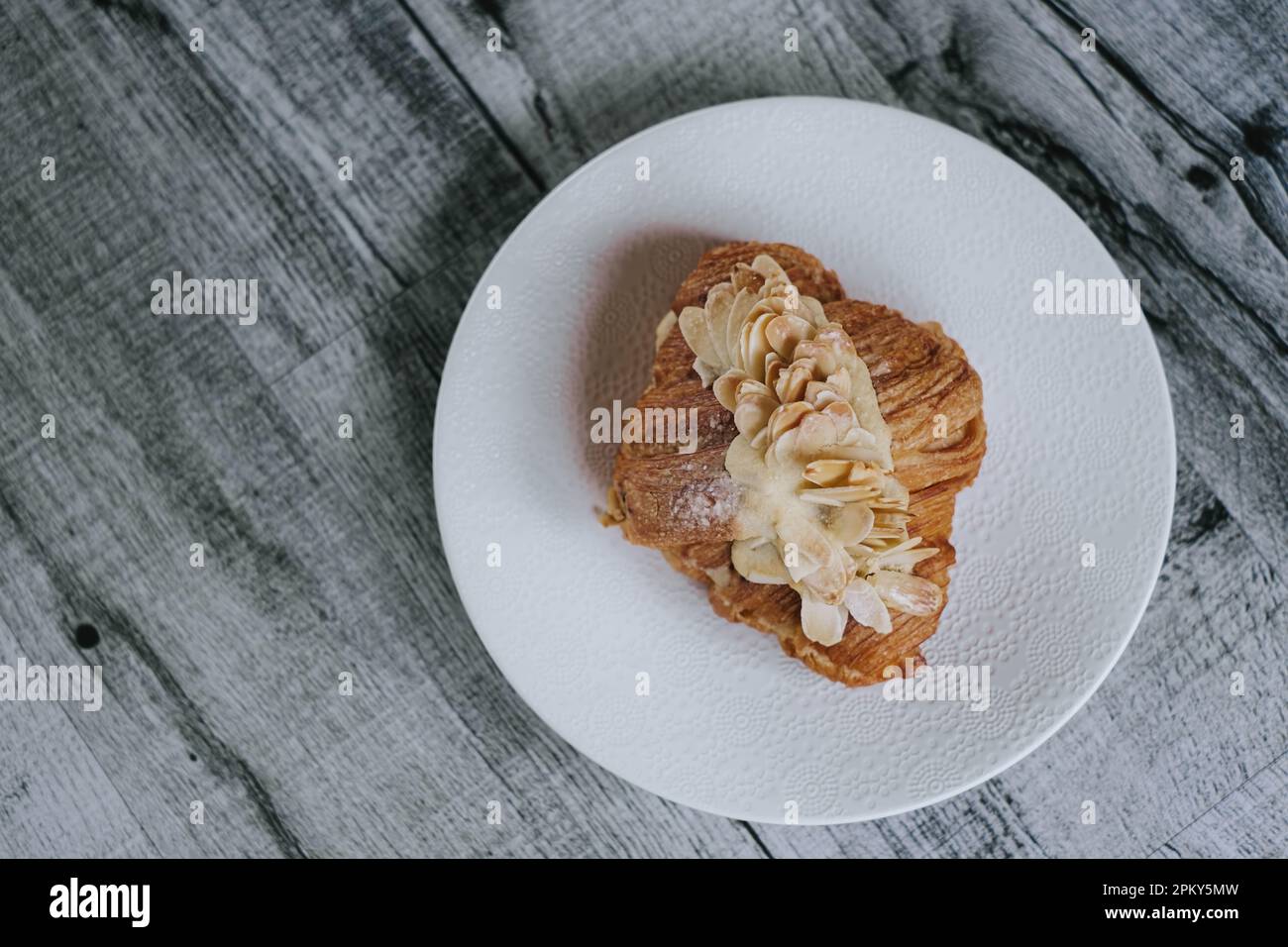 Flat Lay or Top View Shot of a Plate of a Croissant with Almond Topping ...