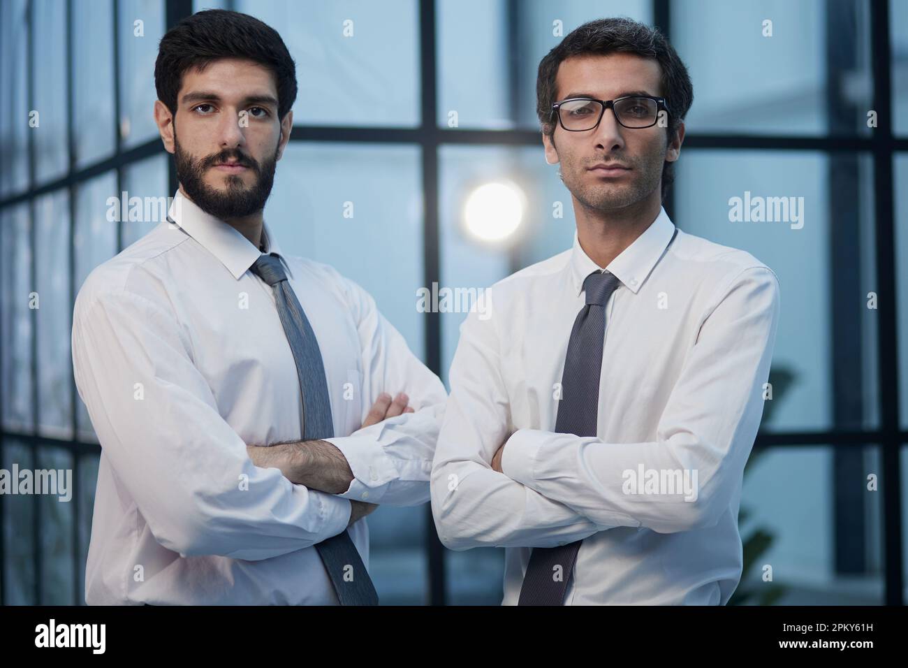 Business successful men of European appearance stand against the ...