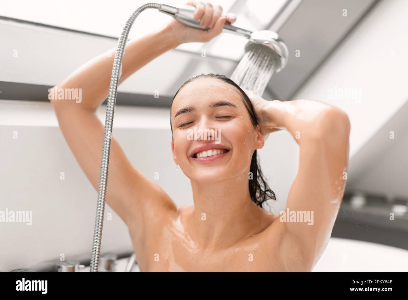 Woman Taking Shower Posing With Eyes Closed Washing Body Indoor Stock Photo - Alamy