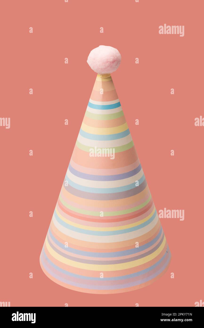 Bright and colorful birthday cap isolated on an orange background ...