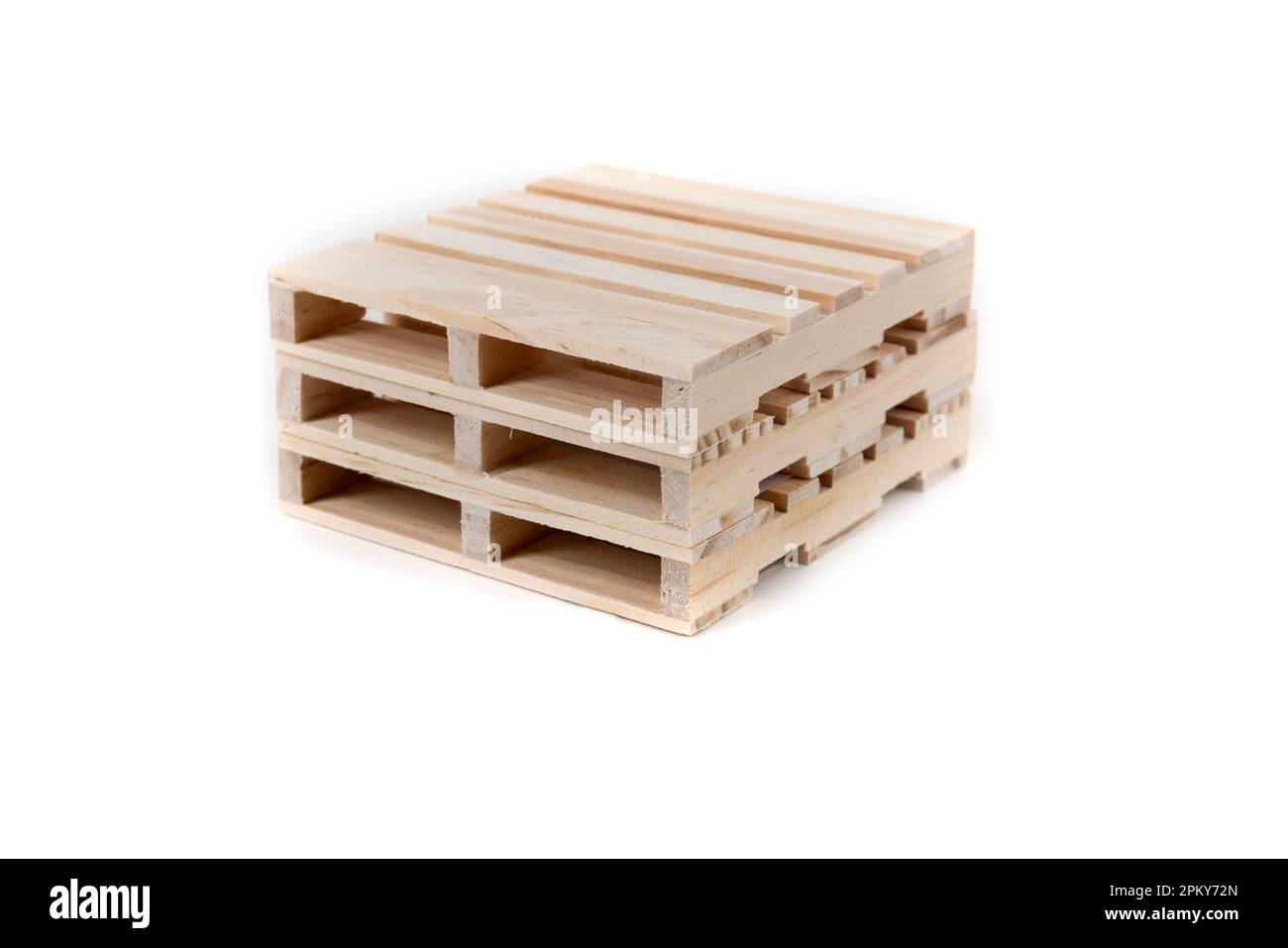 Three dollhouse sized wooden pallets stacked up over white Stock Photo ...