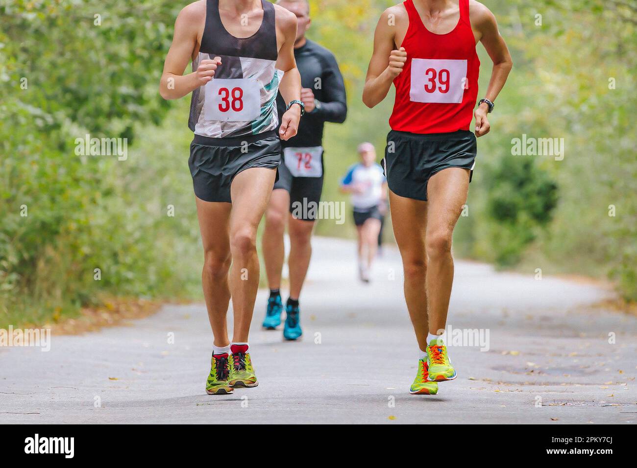 group male runners athletes running race in park road, autumn marathon ...