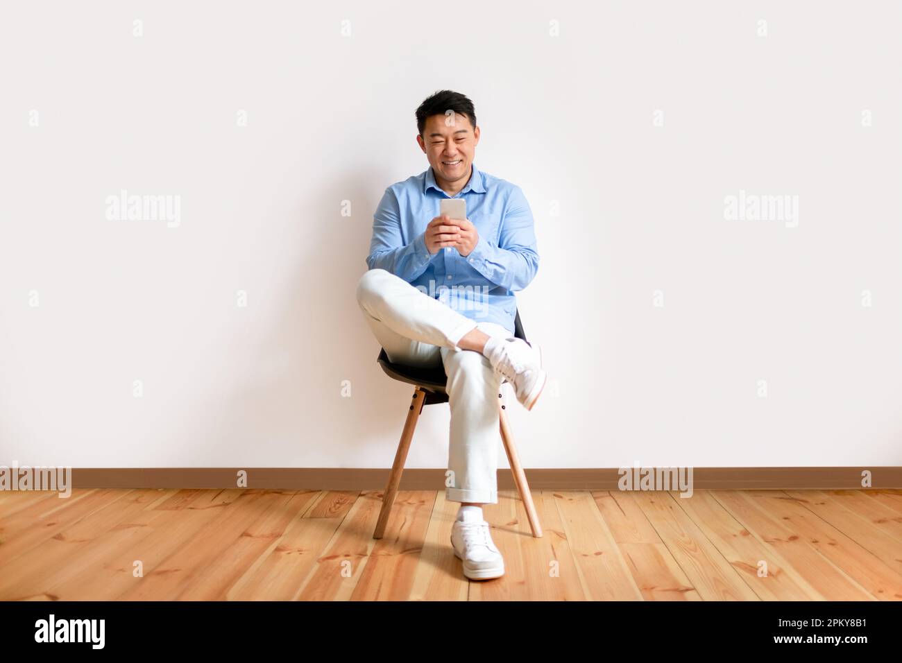 Korean middle aged man using cellphone, texting or surfing internet ...