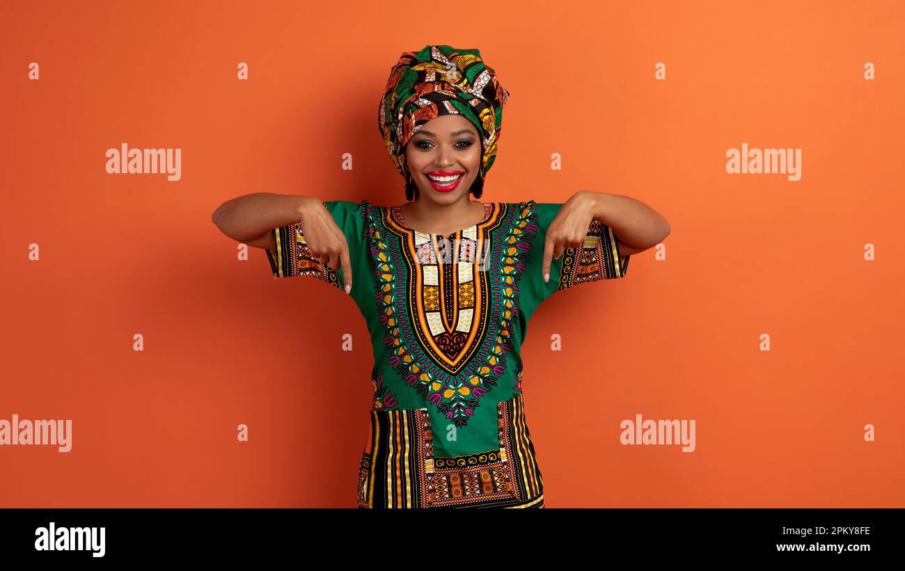 Beautiful black woman in african clothing pointing at herself Stock ...