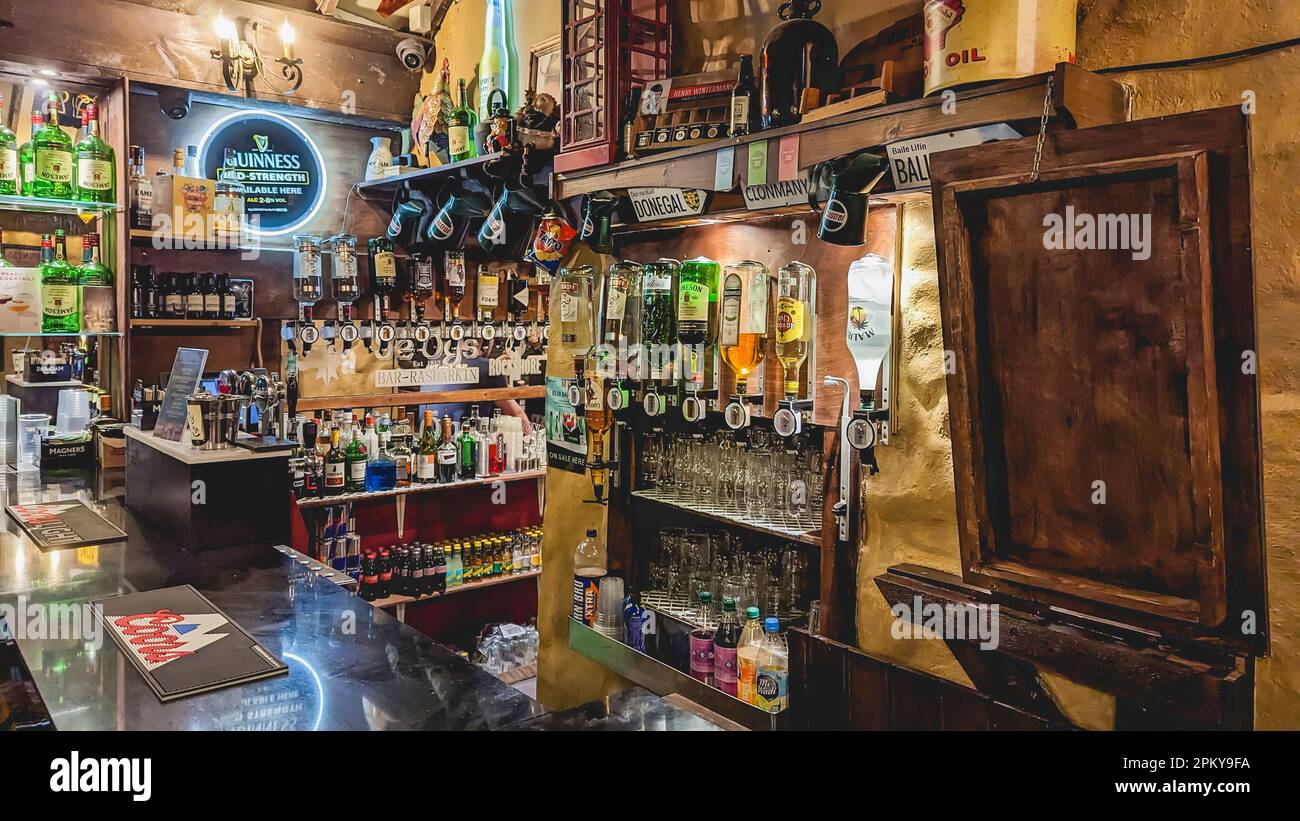 Traditional Irish bar with glasses, bottles, optics and decorative ...