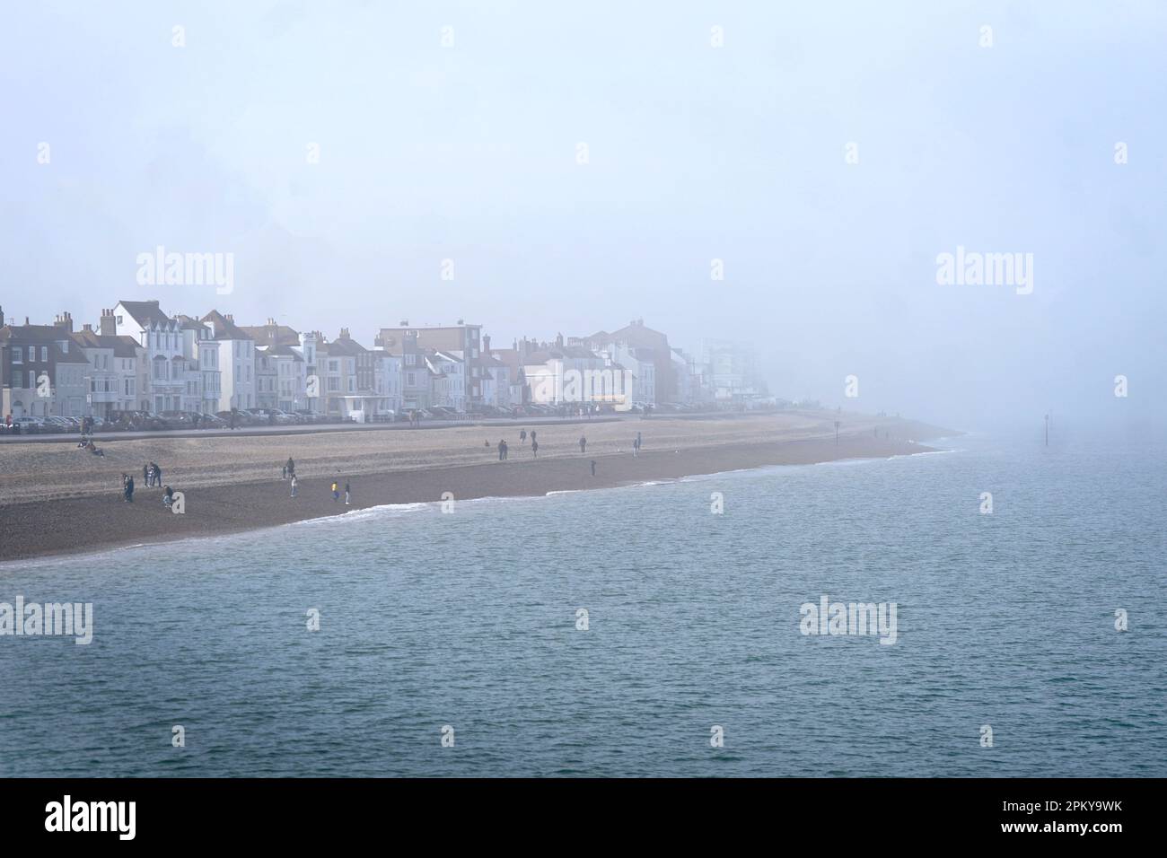 People walk through the mist on the beach in Deal, Kent on Easter ...