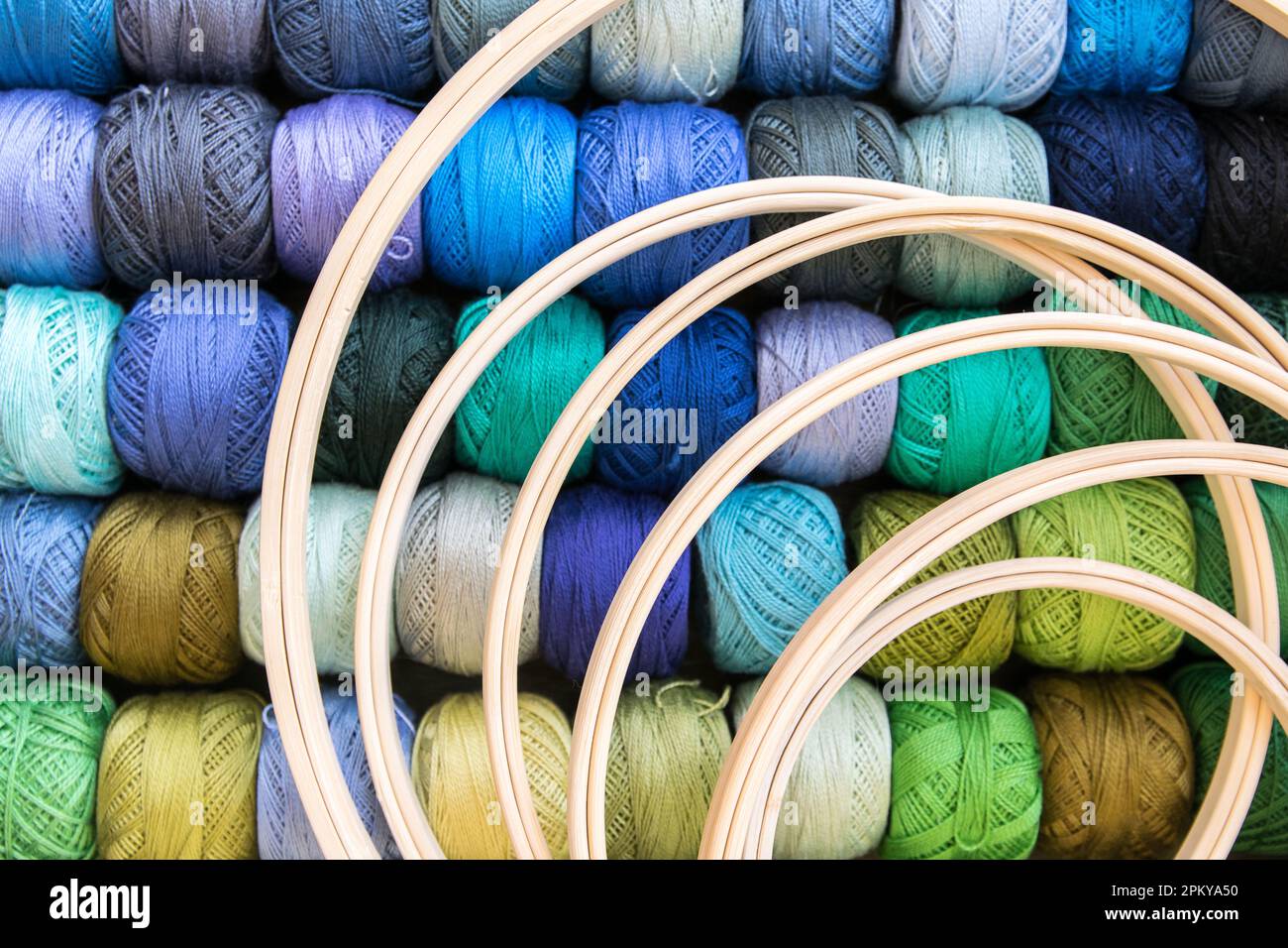 Colorful embroidery thread rolls made of cotton under wooden embroidery ...