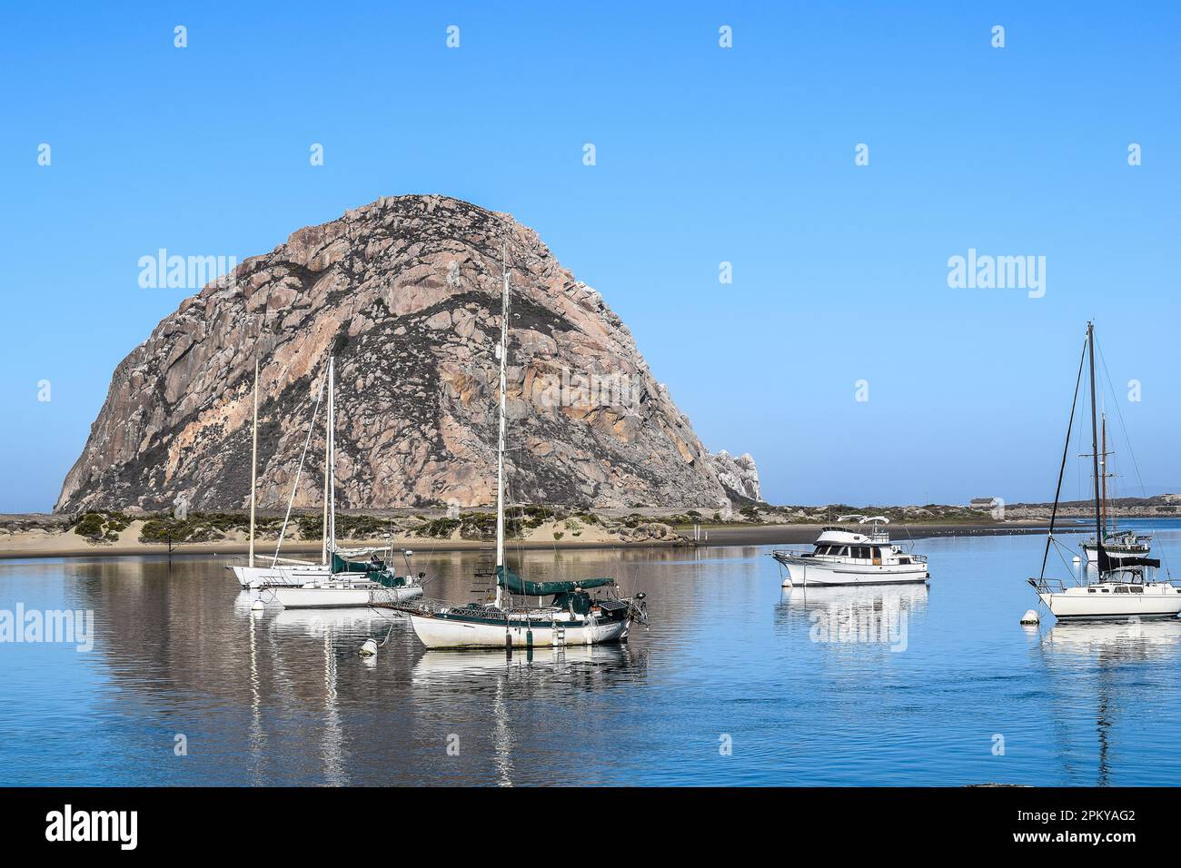 The Morro Rock beside parking boats in Morro Bay, California Stock ...