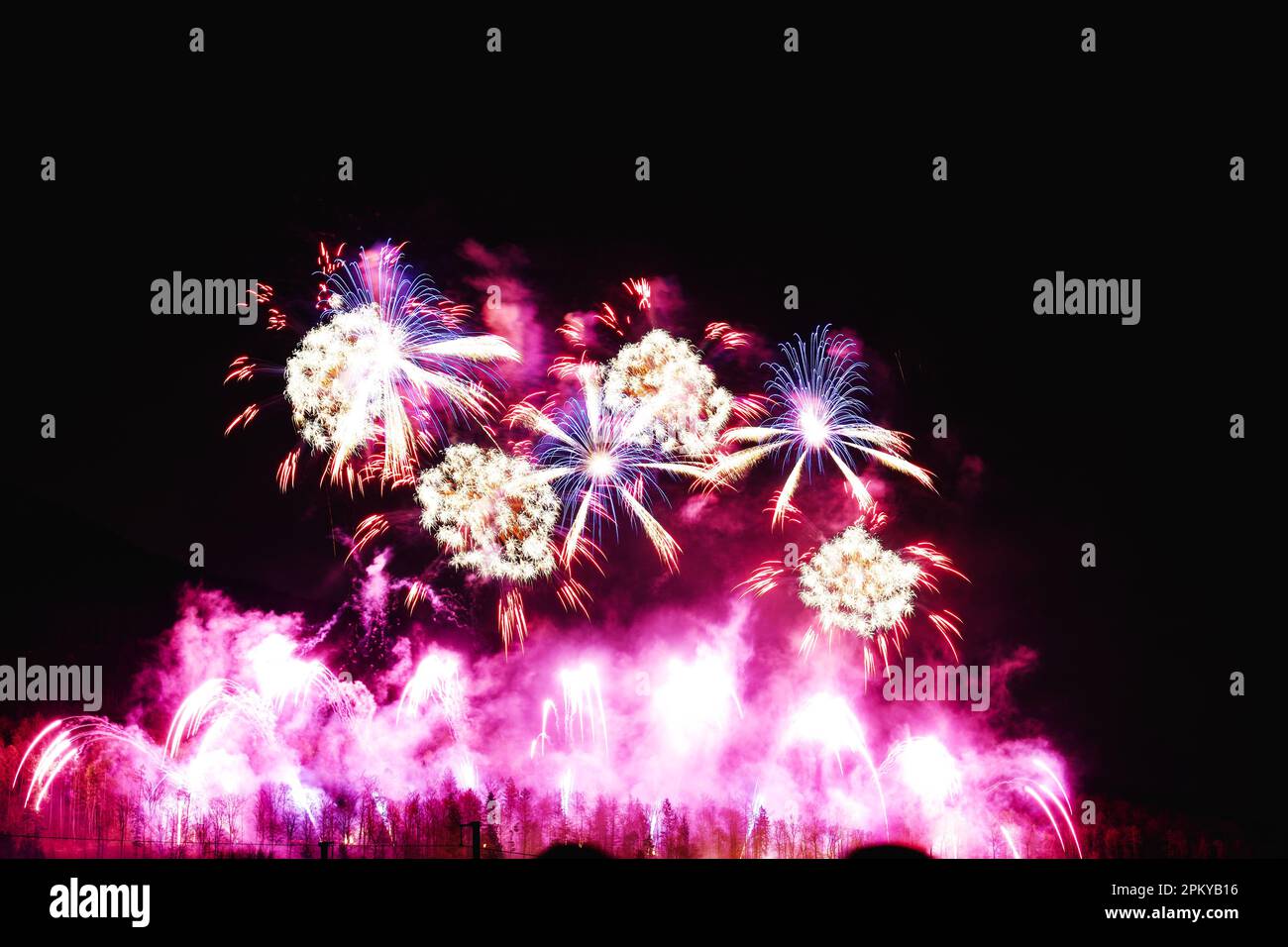 A night-time scene featuring a stunning display of colorful fireworks ...