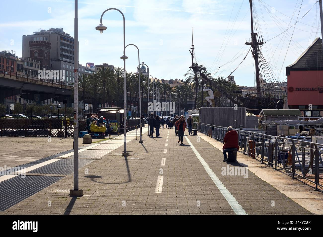 Sidewalk with people passing by and stalls in a pier Stock Photo - Alamy