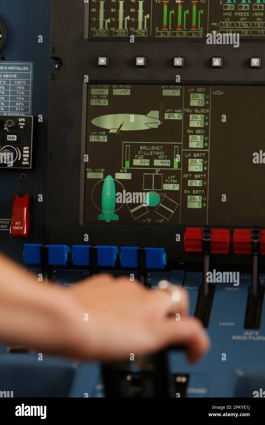 Pilot Katharine Board works a control in the cockpit of Airship Venture ...