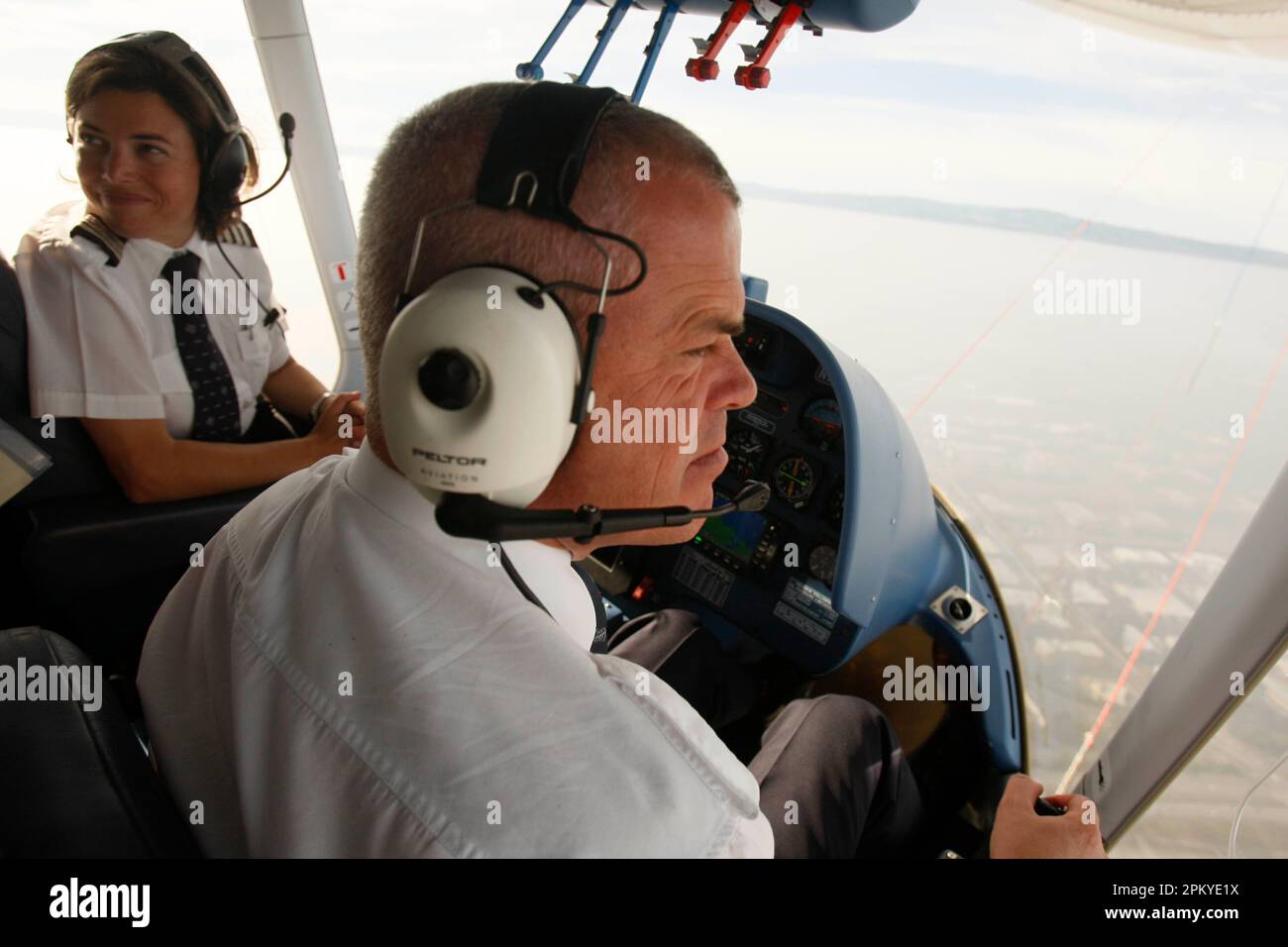 Pilot Fritz Guenther works the controls in the cockpit of the Zeppelin ...