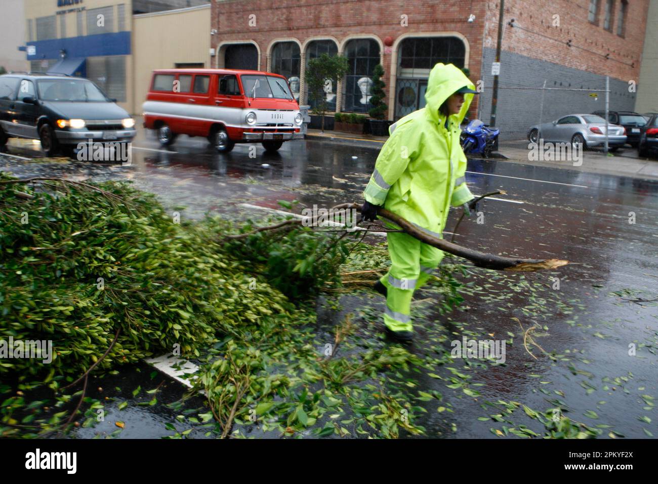 A DPW worker clears parts of a tree that fell onto 7th street in San ...