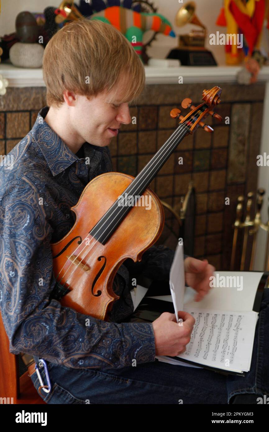 Turtle Island Quartet member Jeremy Kittel looks through a folder of ...