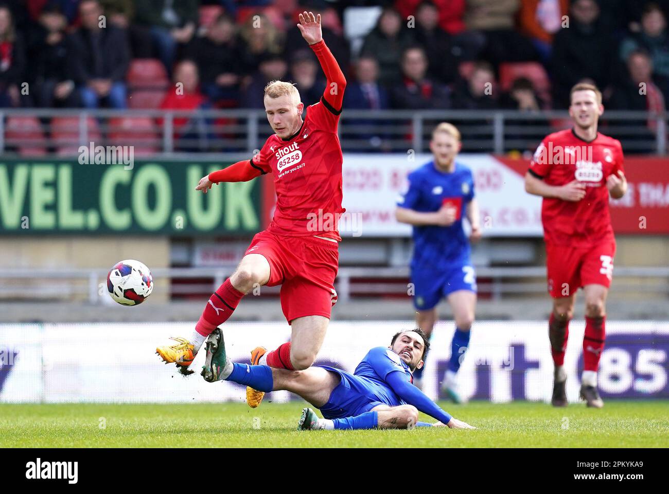 Harrogate Town's Levi Sutton tackles Leyton Orient's Jordan Brown (left ...