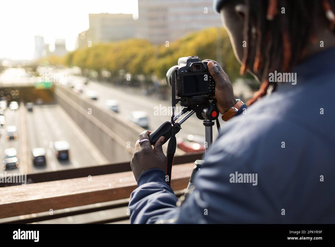 Back view of anonymous African American male taking photo of city on ...